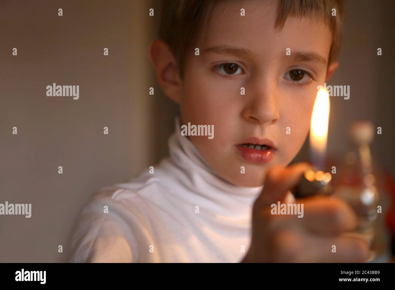 Boy plays with lighter Stock Photo - Alamy