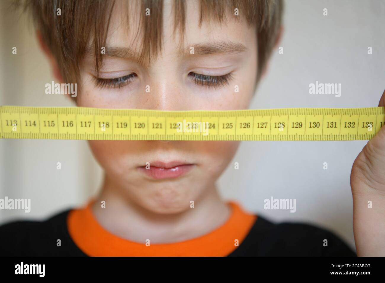 Boy with tape measure Stock Photo - Alamy