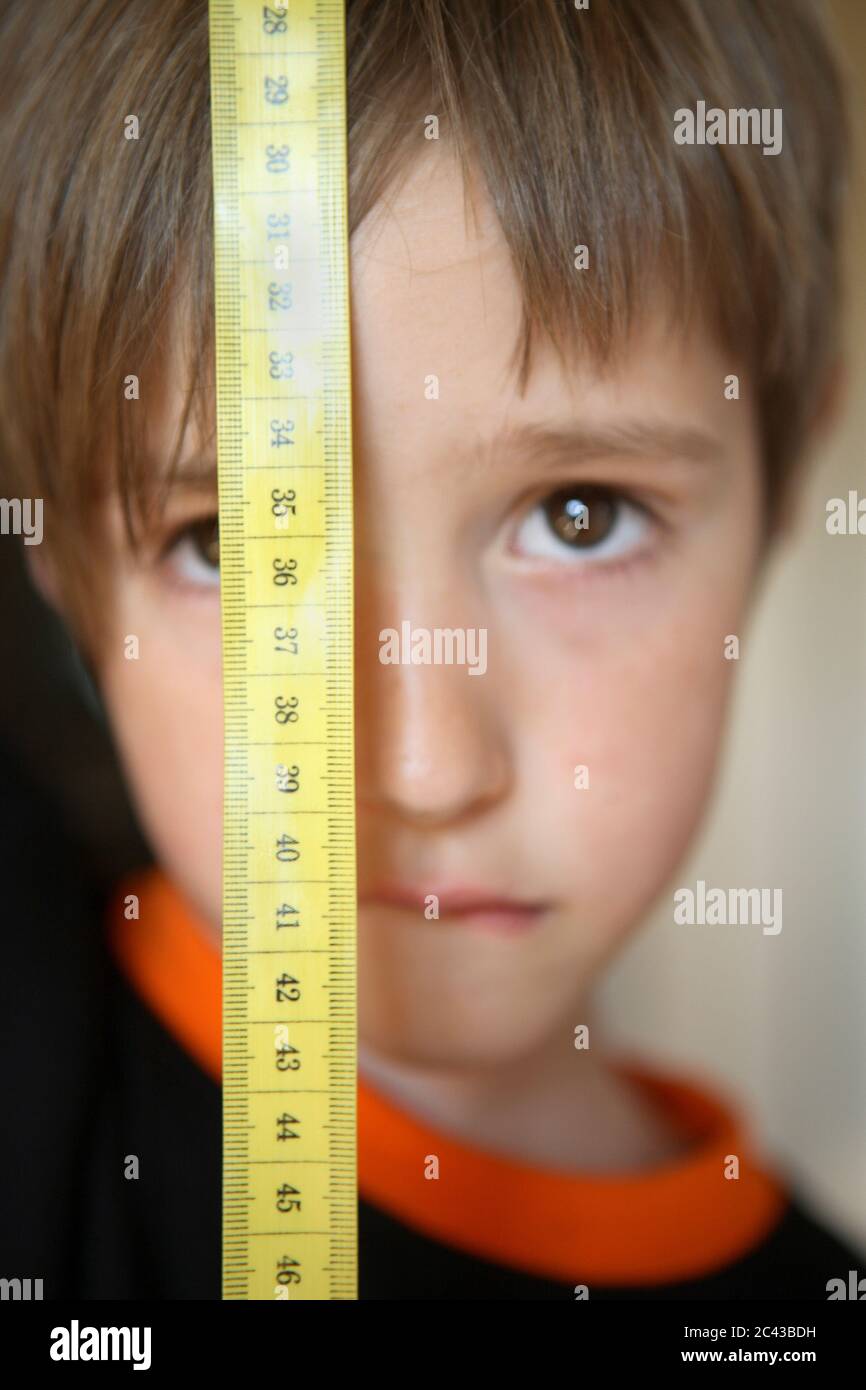 Boy with tape measure Stock Photo - Alamy