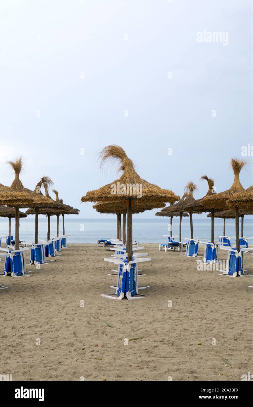 Parasols and tables on the beach, Mallorca, Spain Stock Photo - Alamy