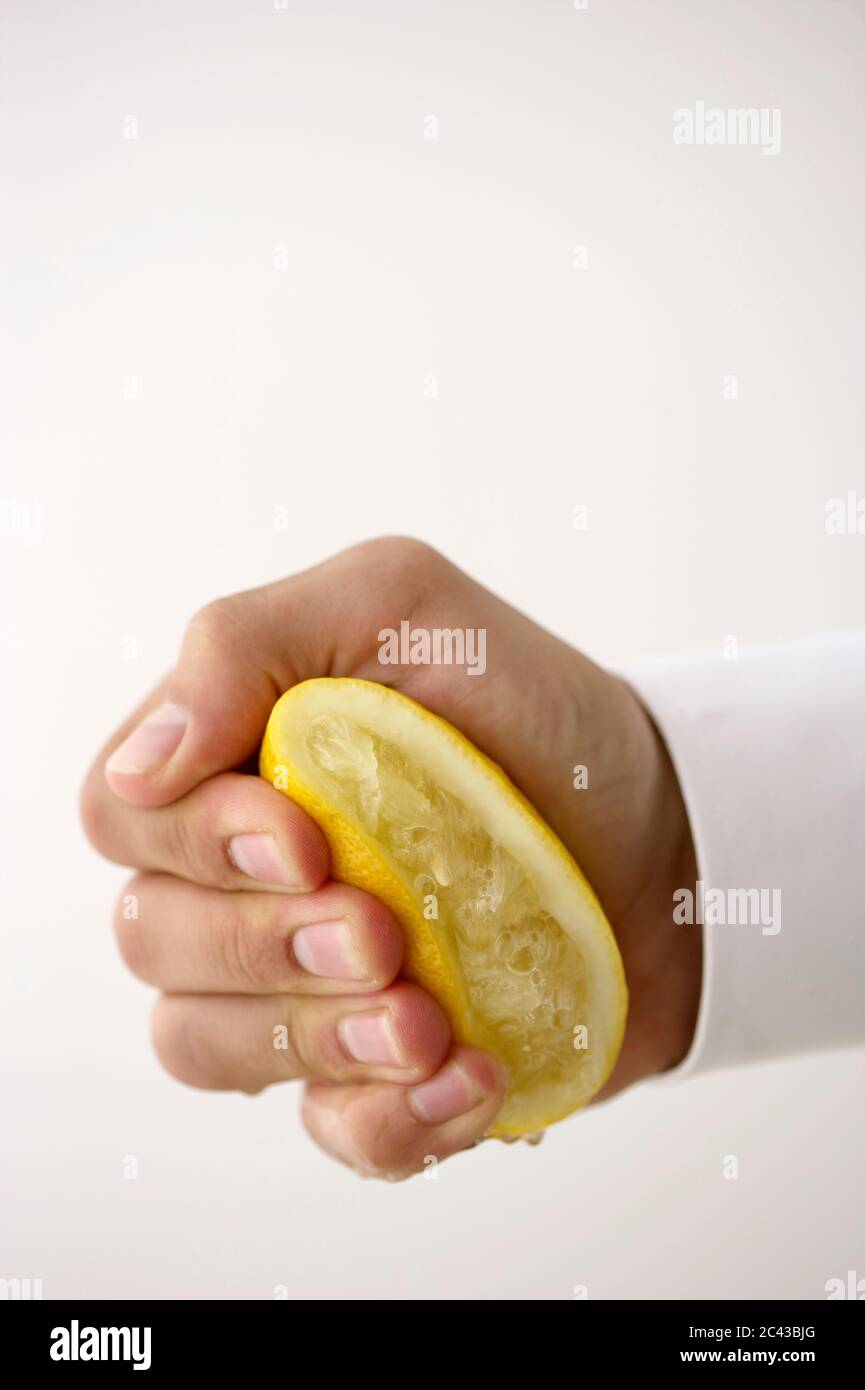 Man squeezes a lemon Stock Photo - Alamy