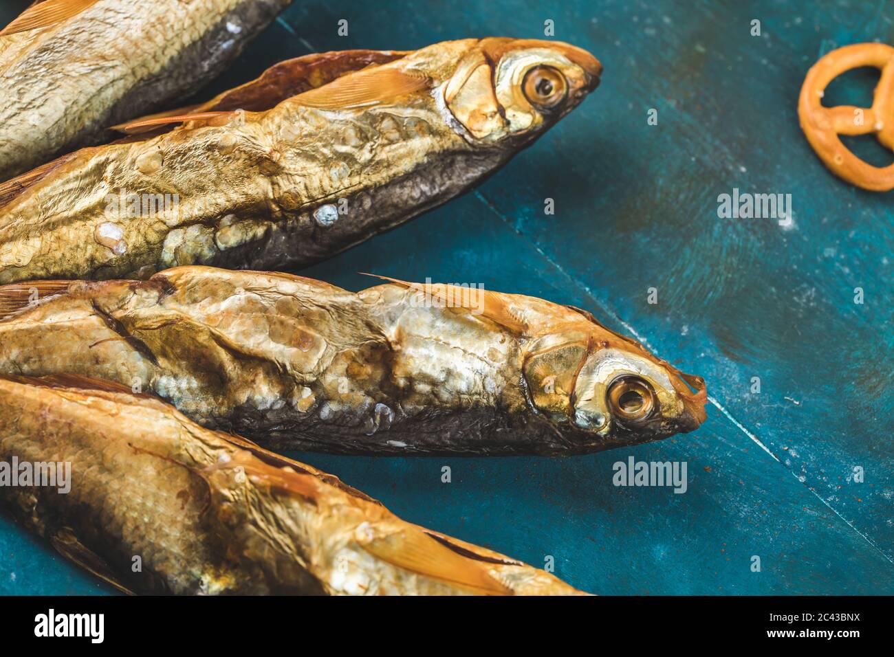 Dried fish snacks on the blue background Stock Photo - Alamy