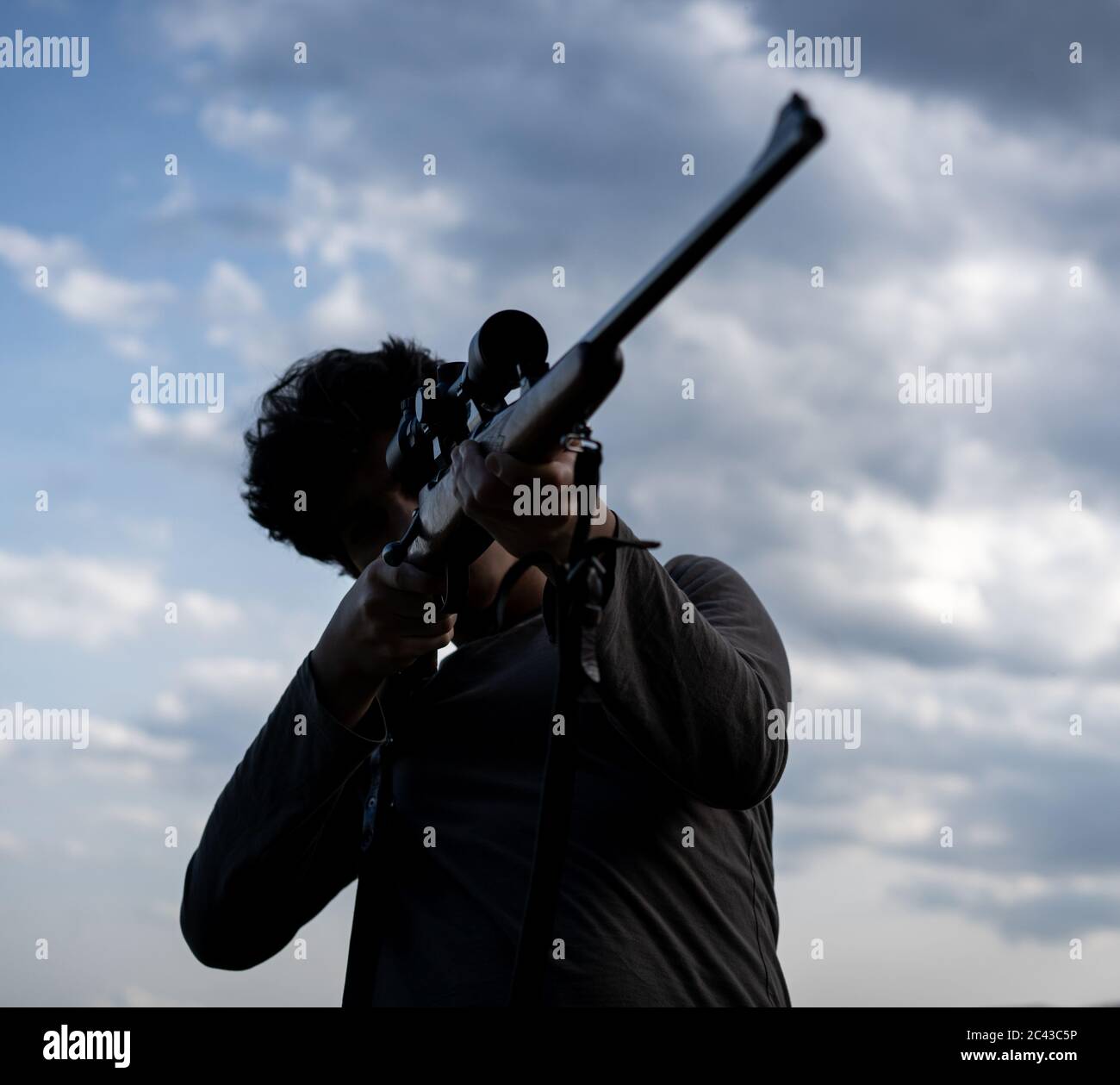 Young man holding rifle with sniper Stock Photo - Alamy
