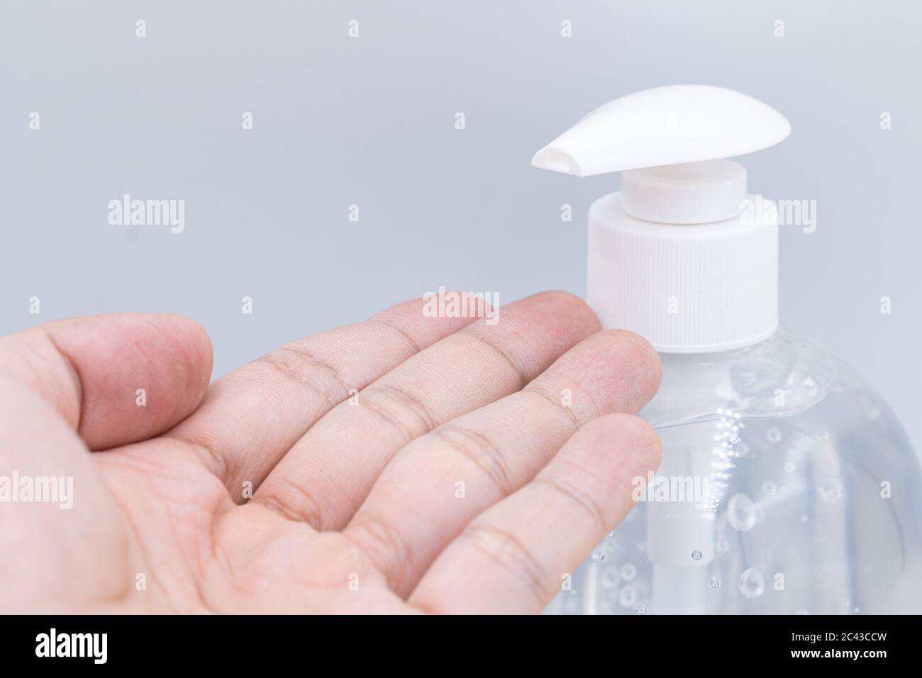 Close up. Clear hand sanitizer in a clear pump bottle isolated on a ...