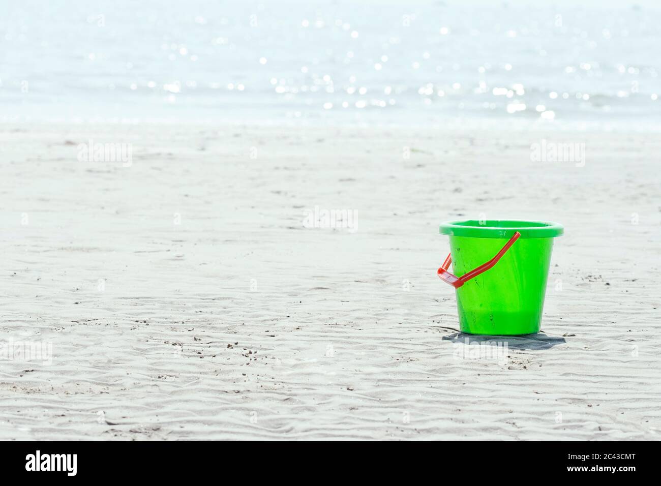 Green bucket on the beach, Amrum, Schleswig-Holstein, Germany Stock ...