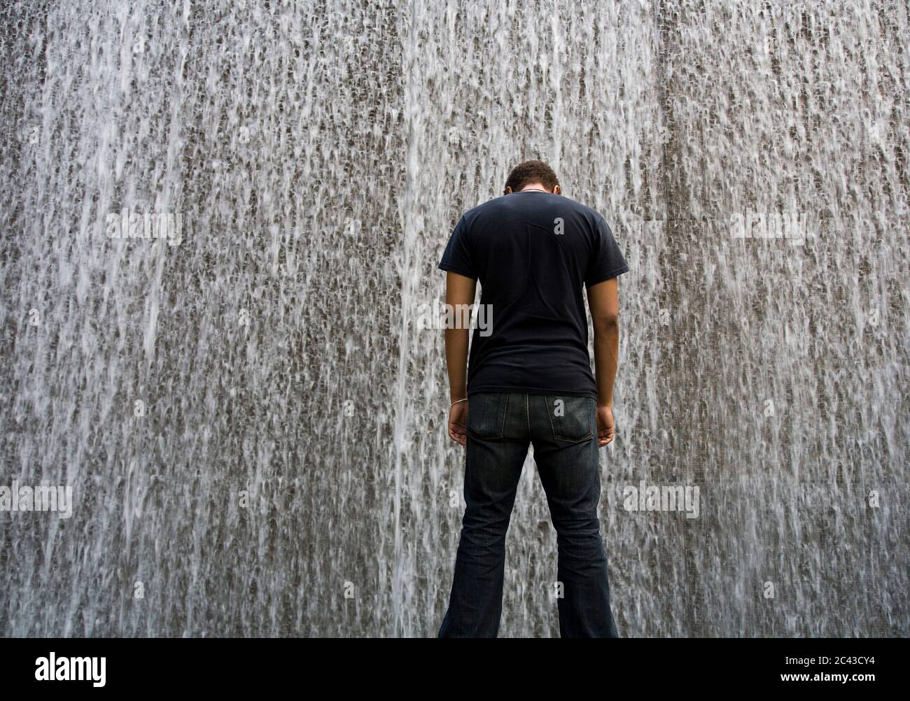 Man is standing in front of a wall Stock Photo - Alamy