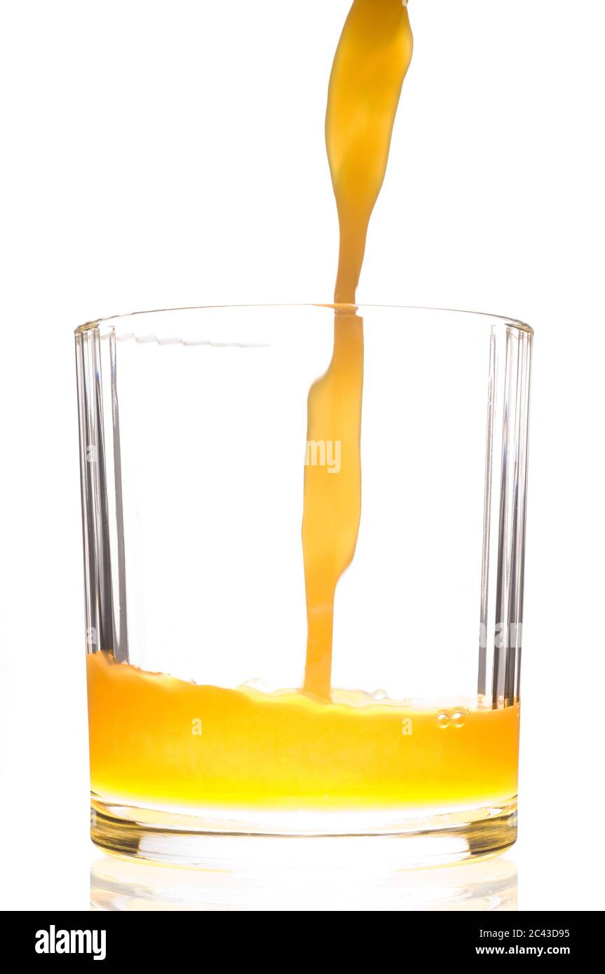 Orange juice is poured out Stock Photo - Alamy