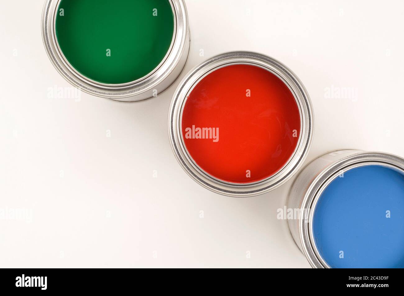 Three cans of red, blue and green color Stock Photo - Alamy