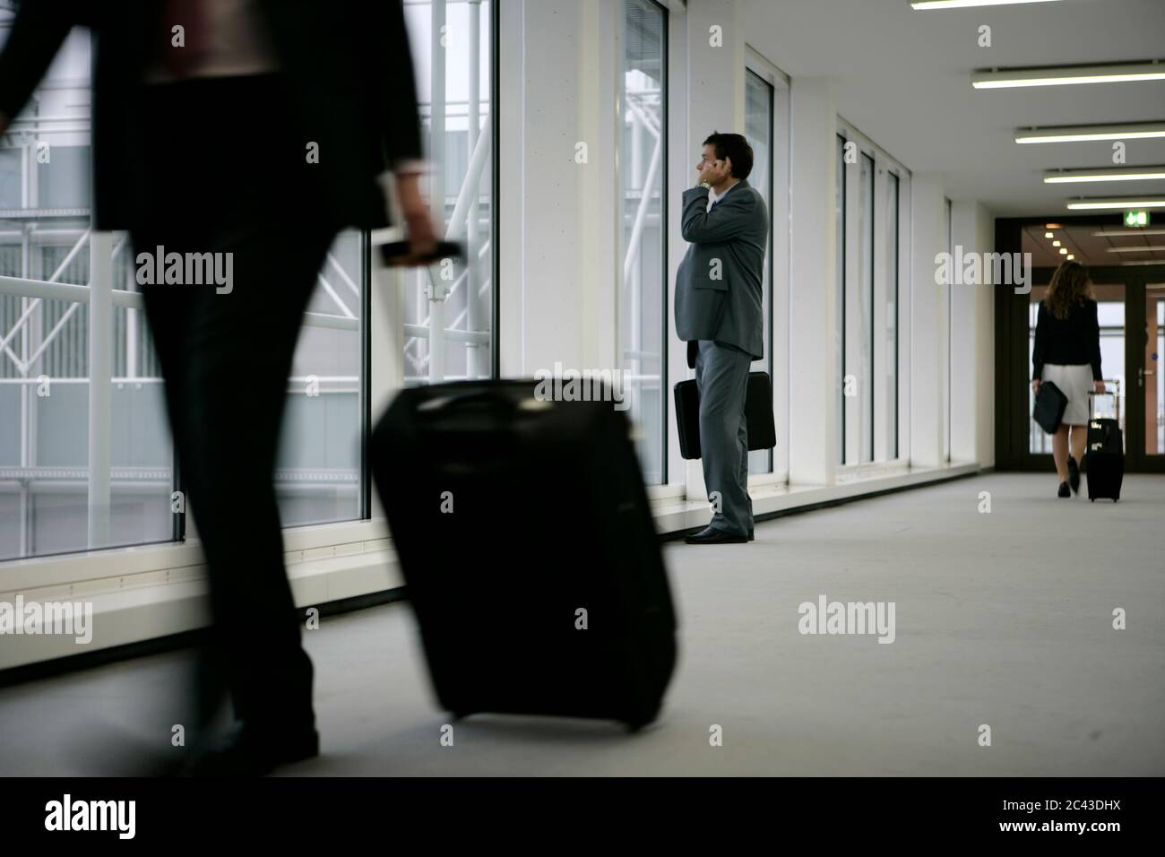 Business people with trolleys run down a corridor Stock Photo - Alamy