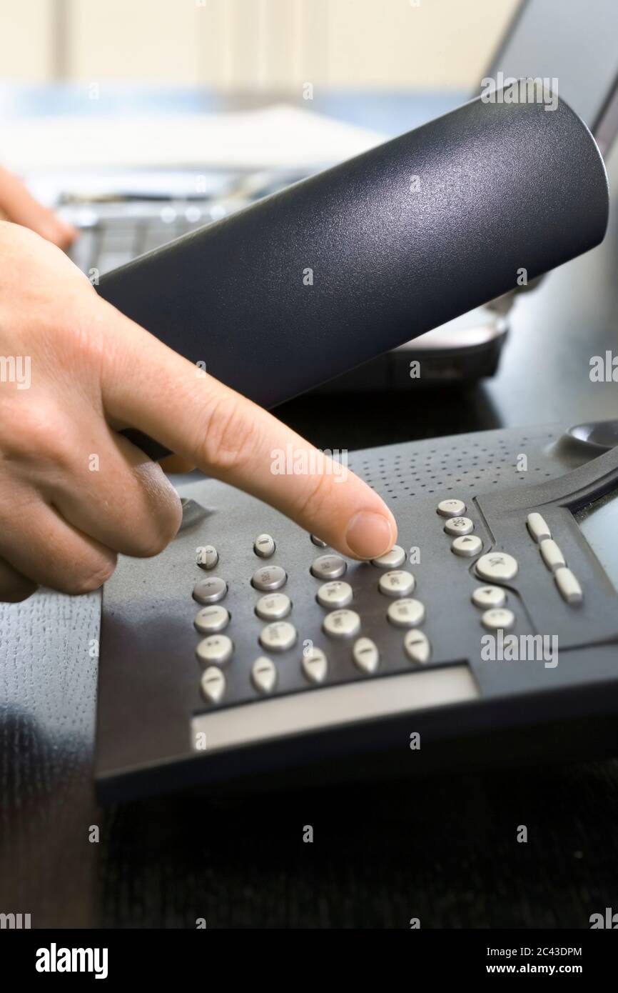 Hand dials a number - call - phone Stock Photo - Alamy