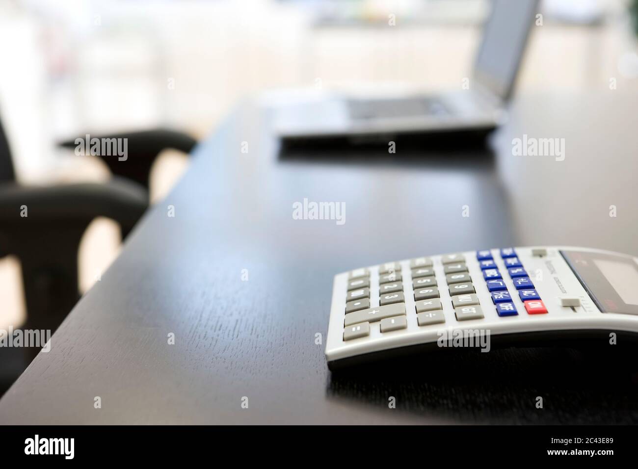Laptop and calculator - desk - office work Stock Photo - Alamy