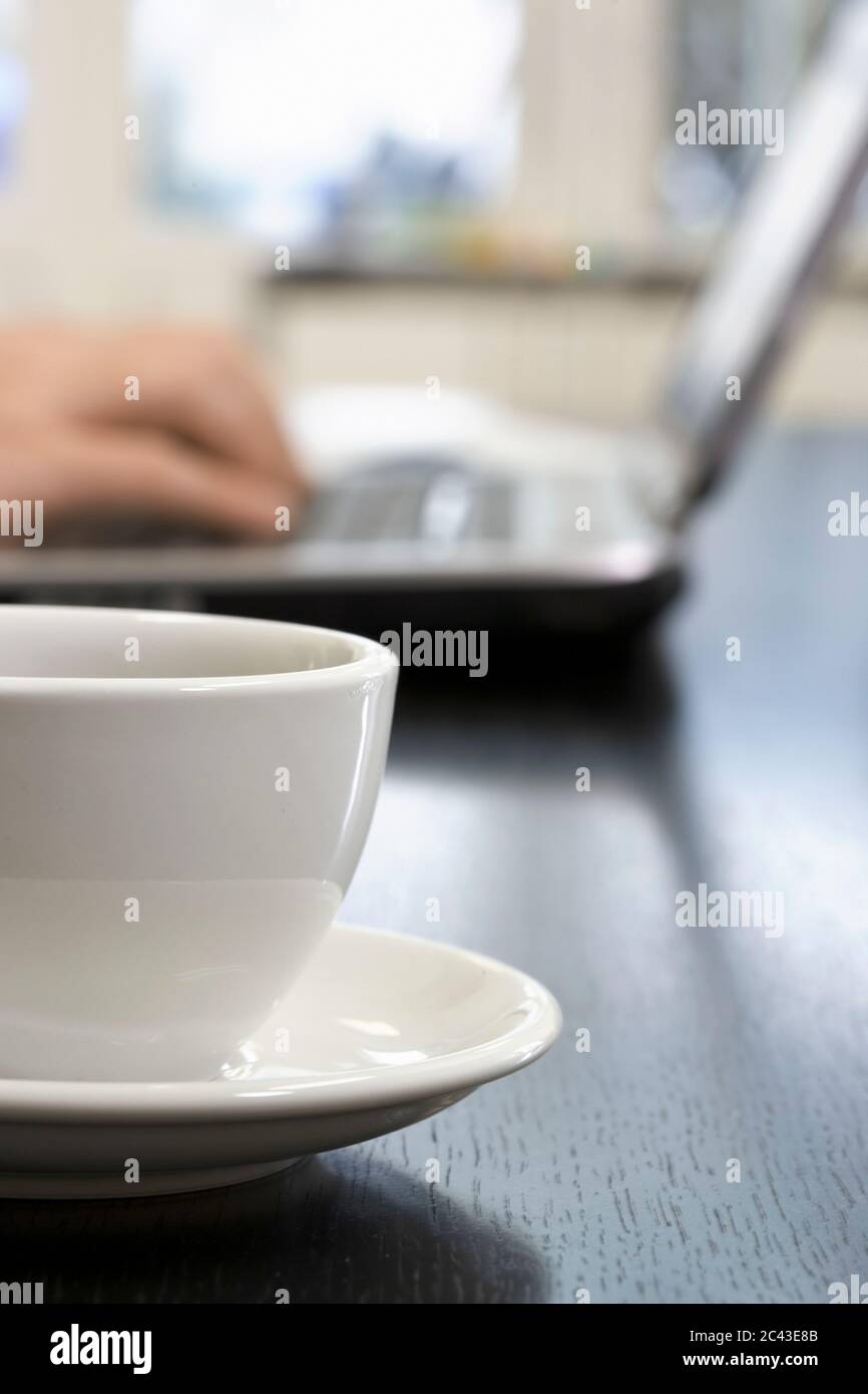 Cup on a desk - office work Stock Photo - Alamy