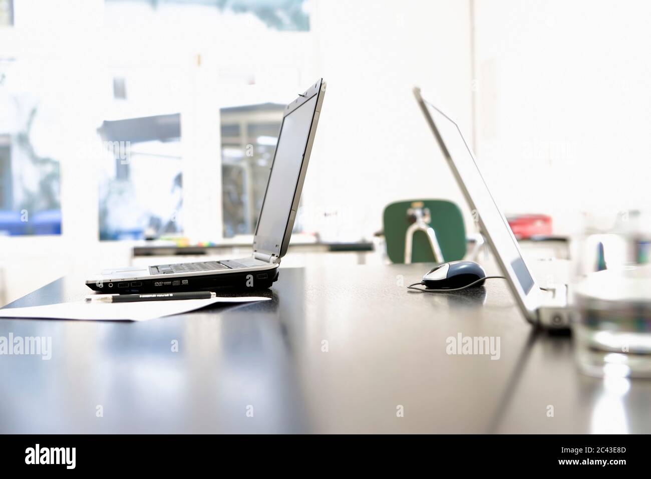 Water glass on a desk - office work Stock Photo - Alamy