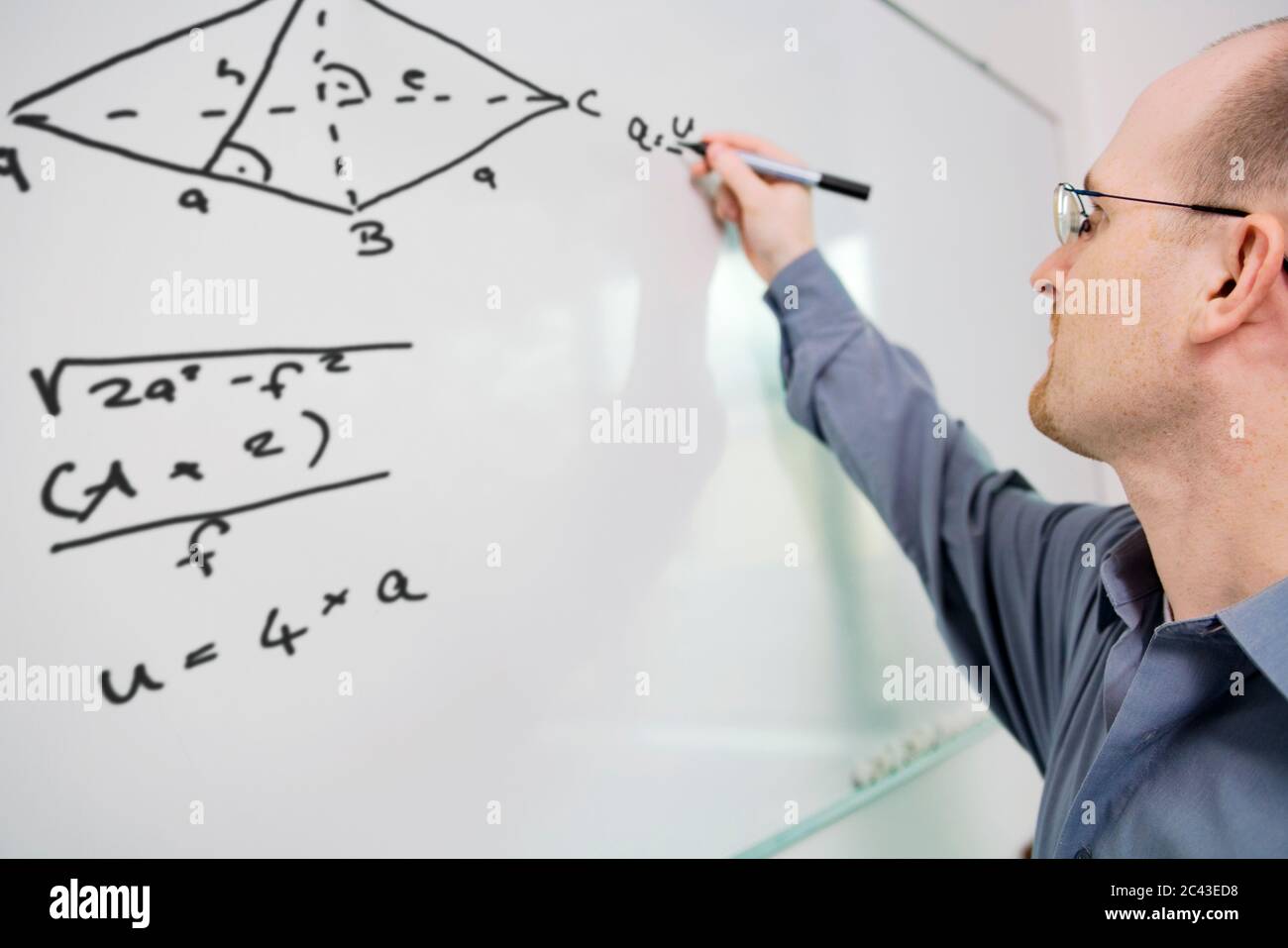 Man describes a math problem on a blackboard Stock Photo - Alamy