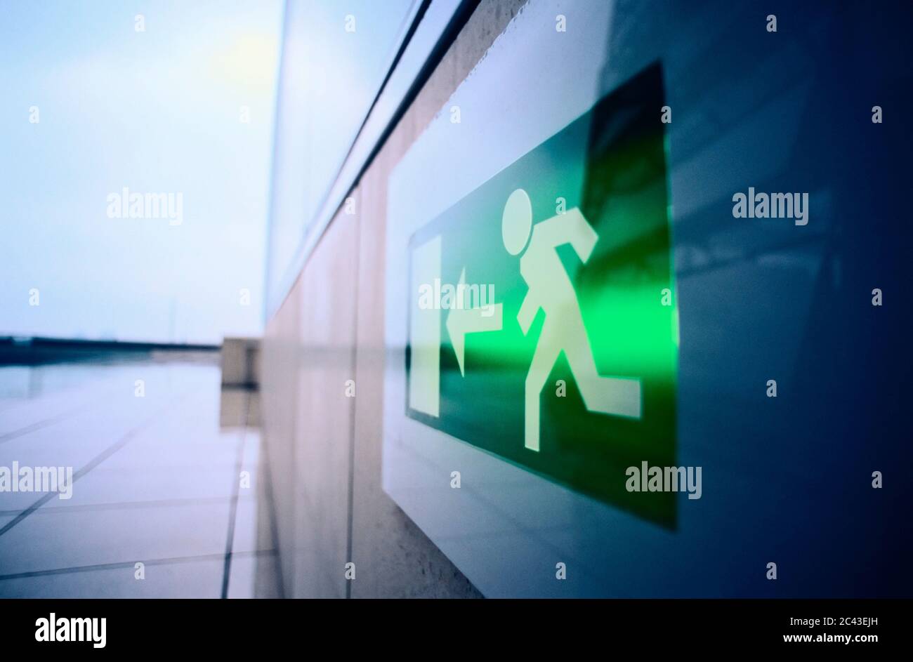 Escape route sign on a building - pictogram Stock Photo - Alamy