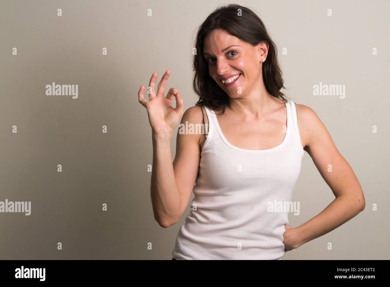 Portrait of happy beautiful woman giving ok sign Stock Photo - Alamy