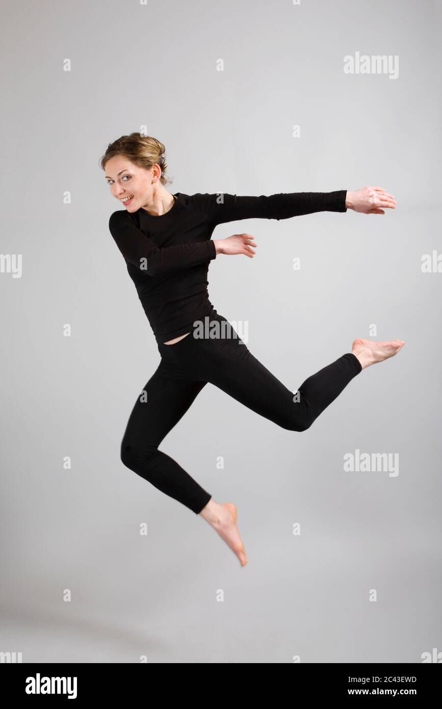 Young woman in black leotard jumps, Berlin, Germany Stock Photo - Alamy