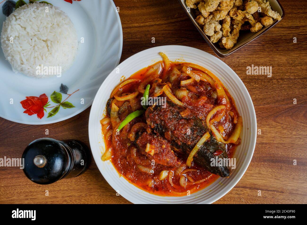 Fried silver catfish cooked with spicy sambal red chilli and onion with ...