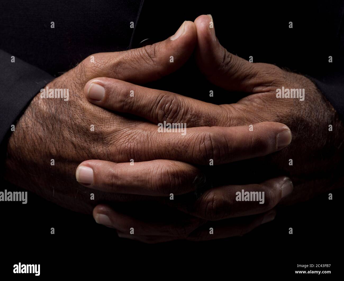 Folded hands of a man Stock Photo - Alamy