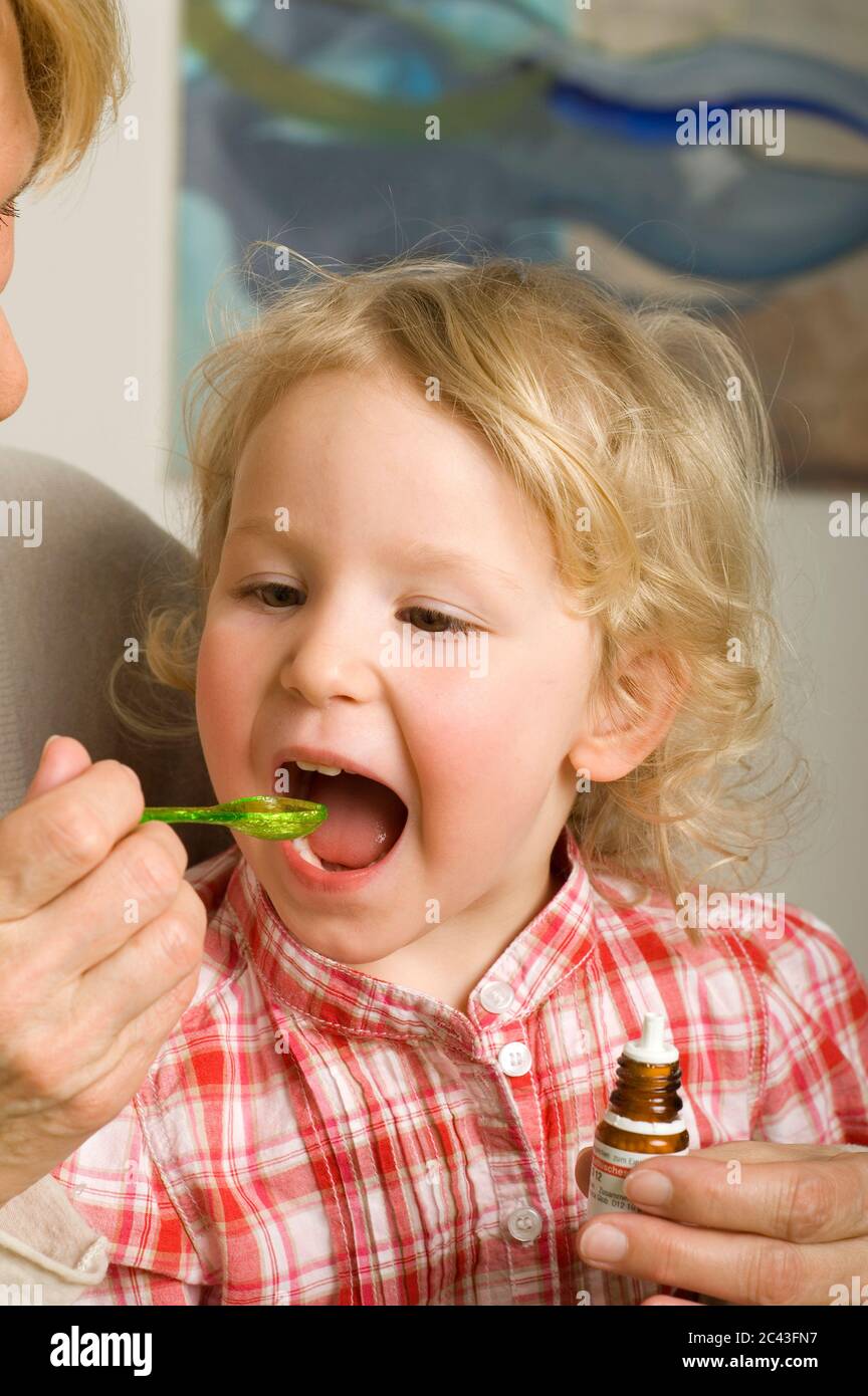 Infant is given medication Stock Photo - Alamy