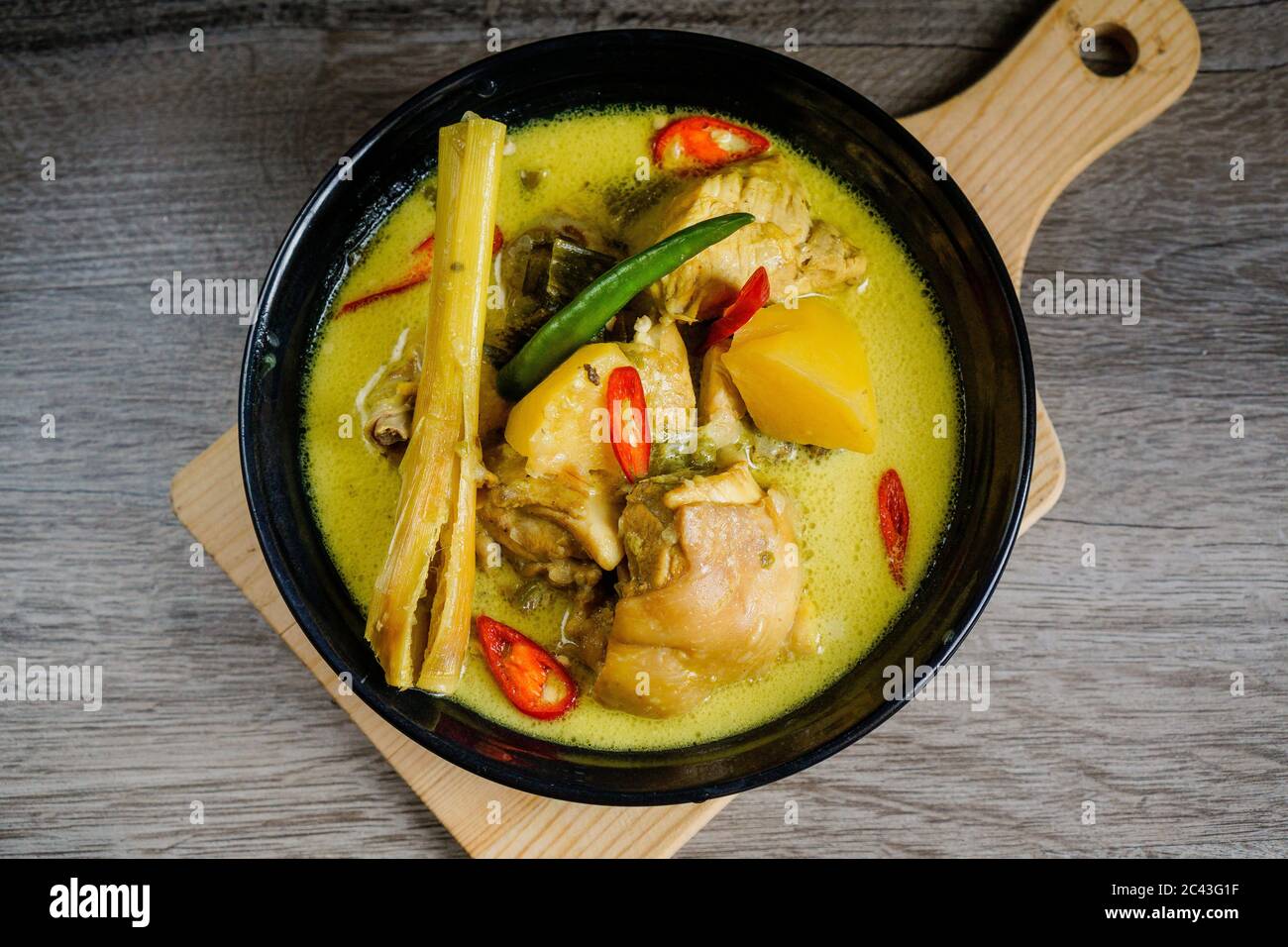 Chicken in turmeric coconut curry with spicy bird chili or thai chili ...