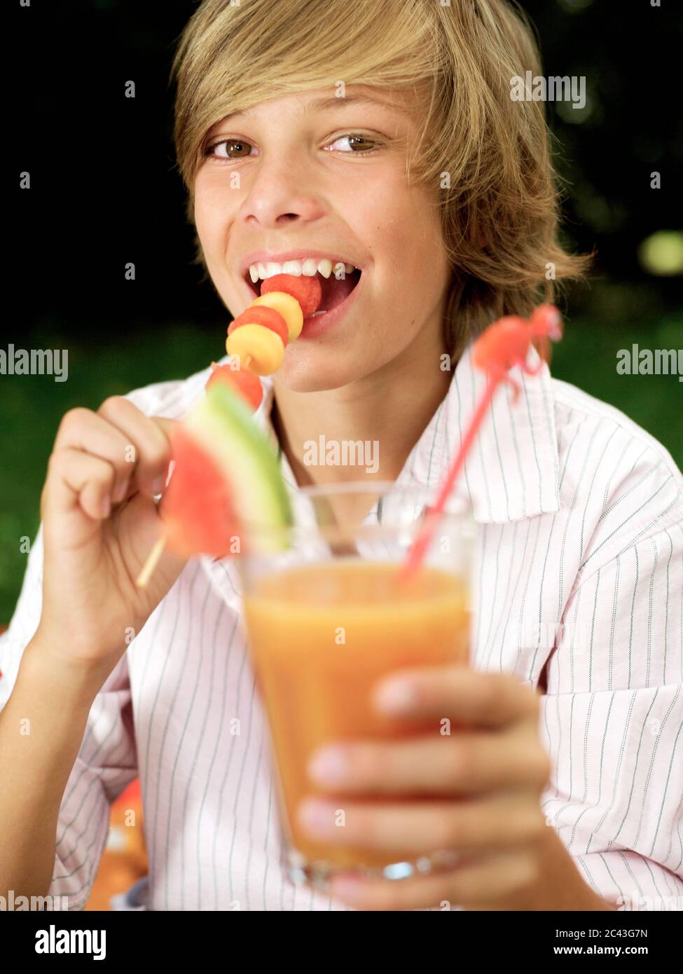 Teenage boy at a birthday party with a glass of juice, Munich, Bavaria ...