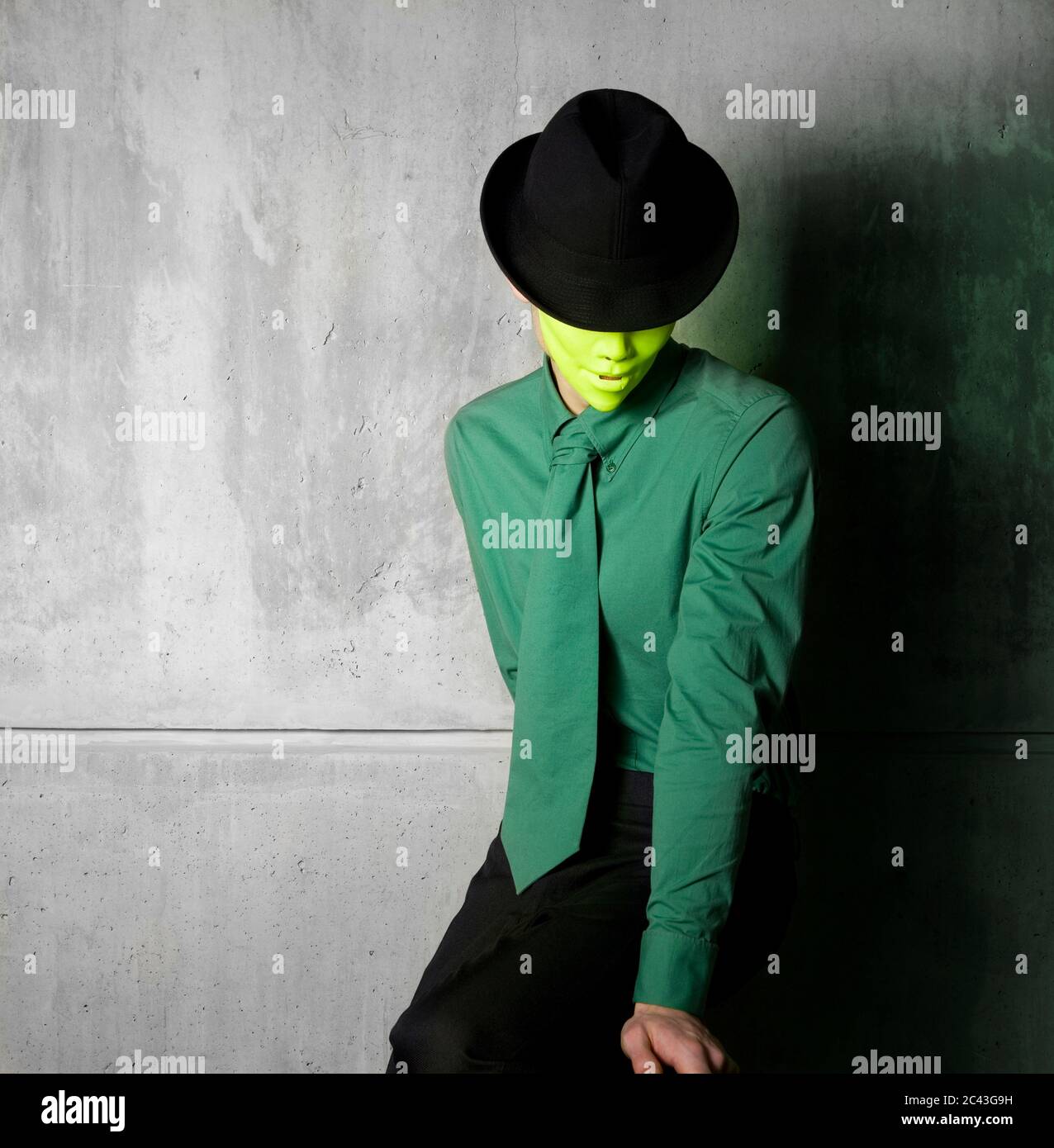 Man wearing mask in front of concrete wall Stock Photo - Alamy