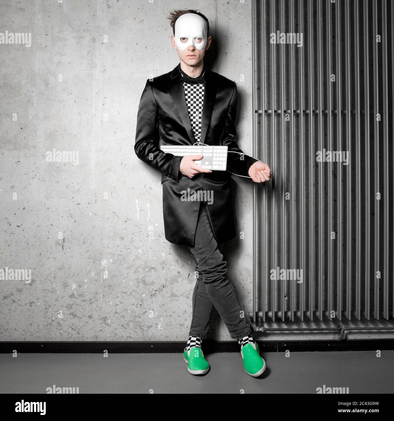 Man wearing mask in front of concrete wall Stock Photo - Alamy