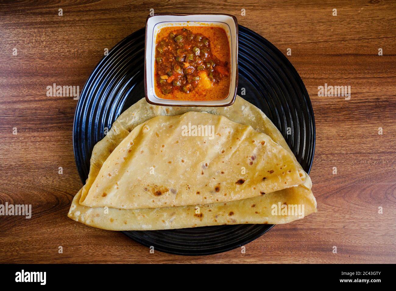 Chapati with chicken curry mix with sardine sambal Stock Photo - Alamy