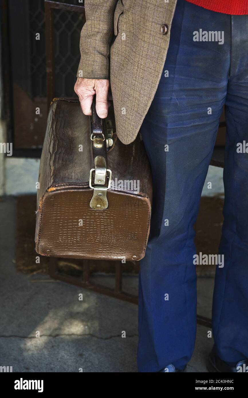 Elderly man carries old fashioned bag, Ballarat, Victoria, Australia ...