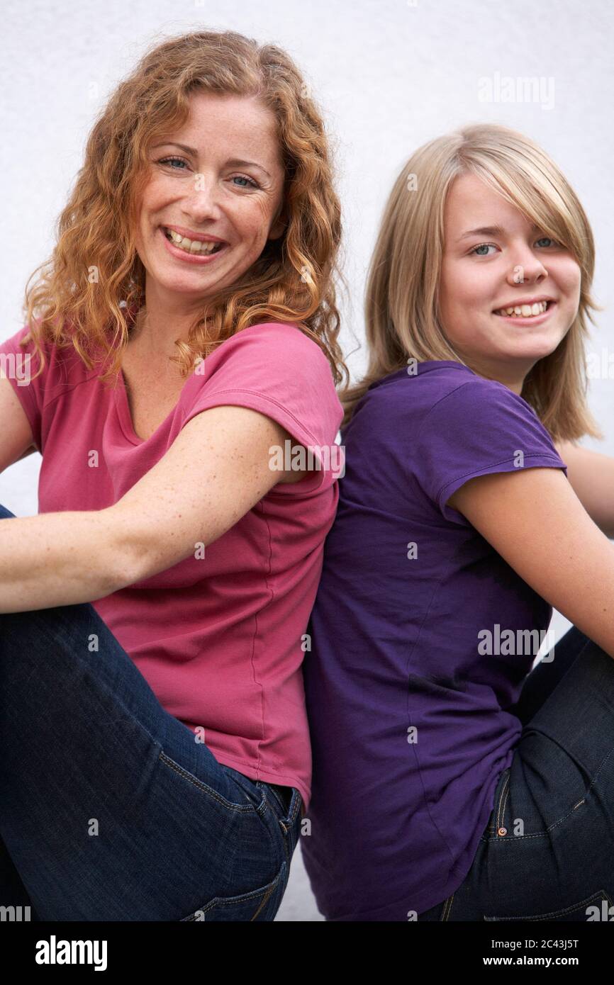 Mother and daughter sit back to back, Vienna, Austria Stock Photo - Alamy