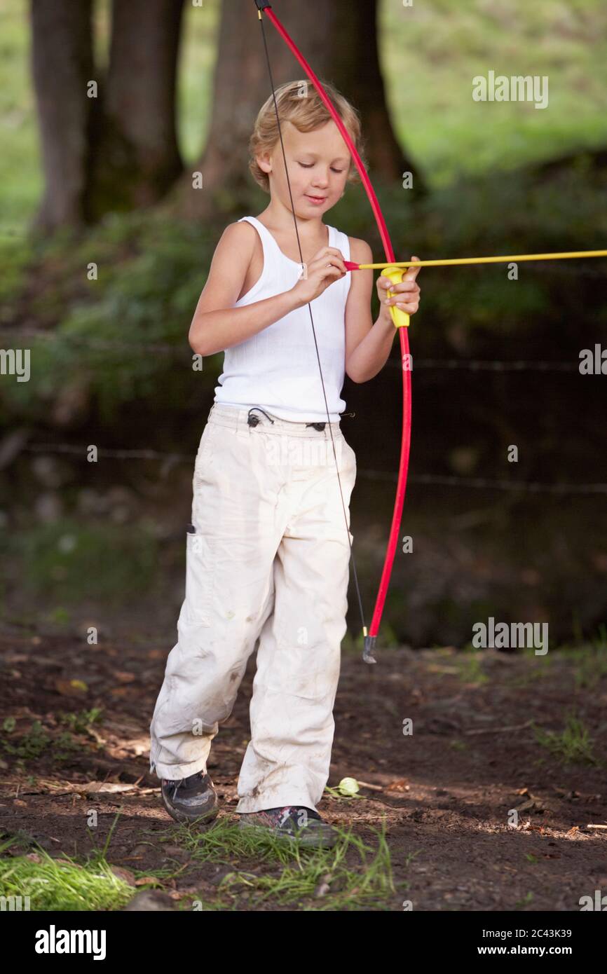 Boy with a bow and arrow Stock Photo - Alamy