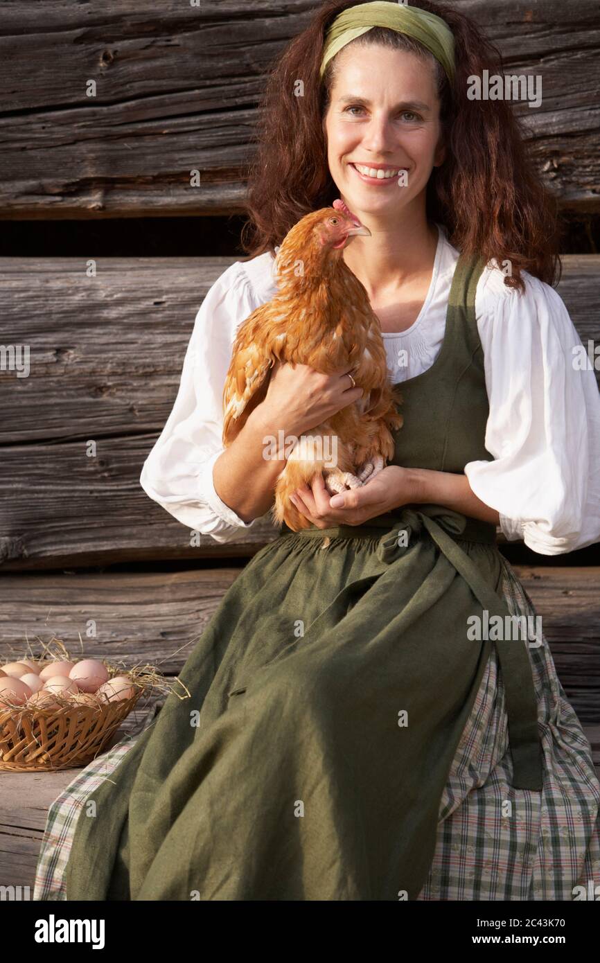 Woman holds chicken in her arms Stock Photo - Alamy