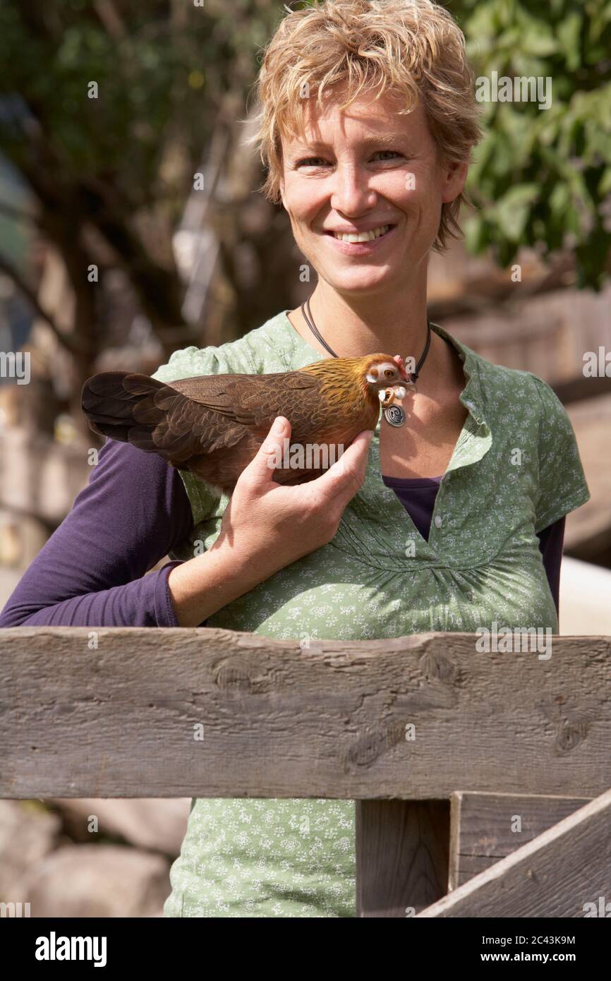Woman with chicken in her arms Stock Photo - Alamy