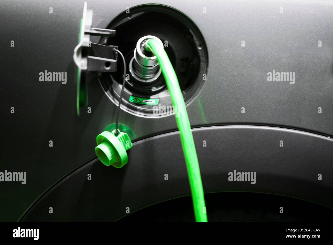 Electric car is being charged Stock Photo - Alamy