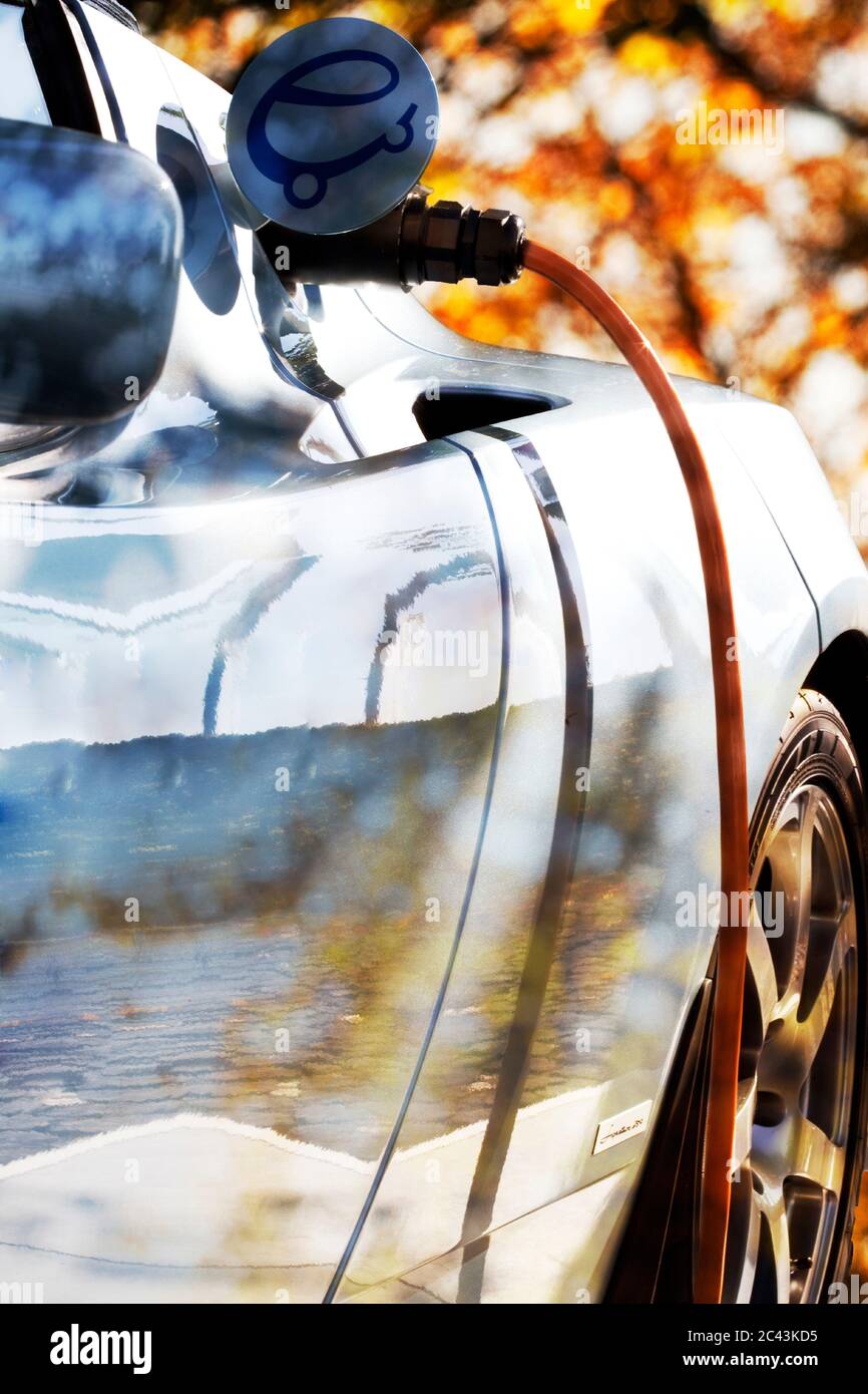 Electric car is being charged Stock Photo - Alamy