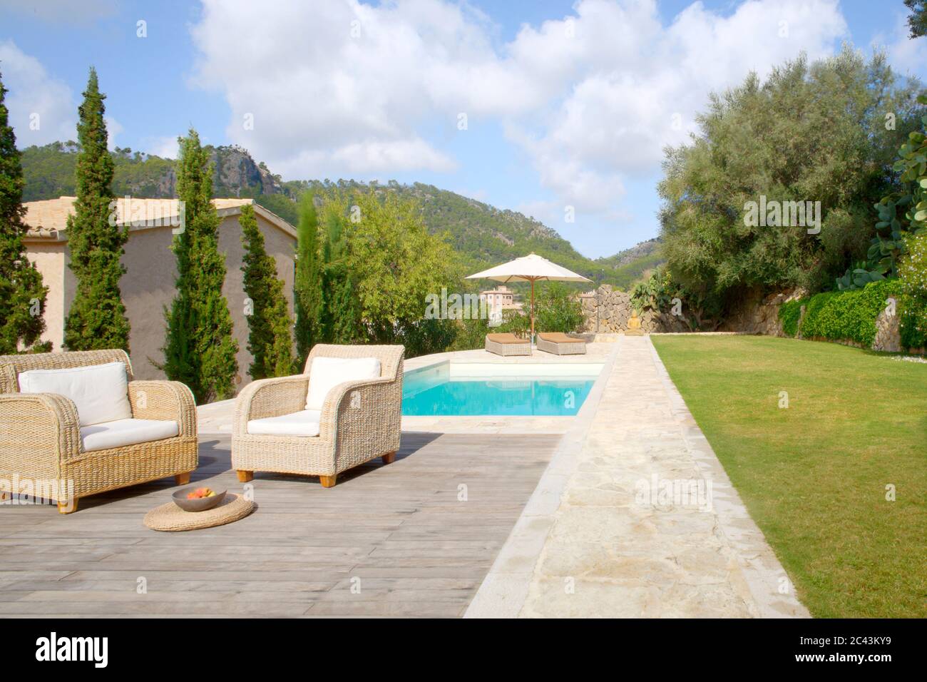 Terrace with wicker chairs and swimming pool, Andratx, Mallorca, Spain ...