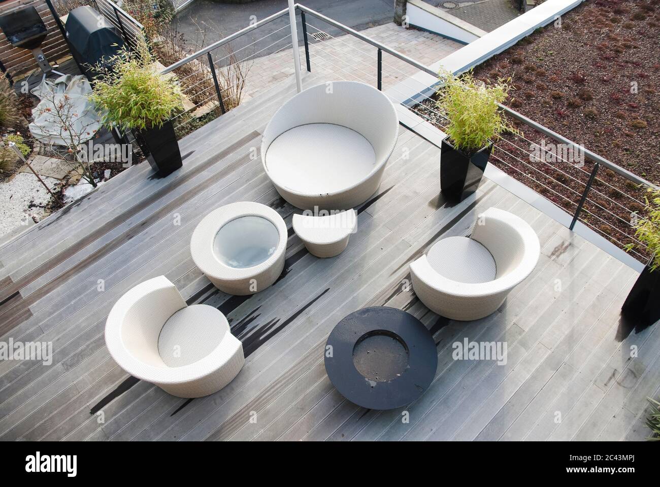 Modern terrace with round seats and flower pots Stock Photo - Alamy