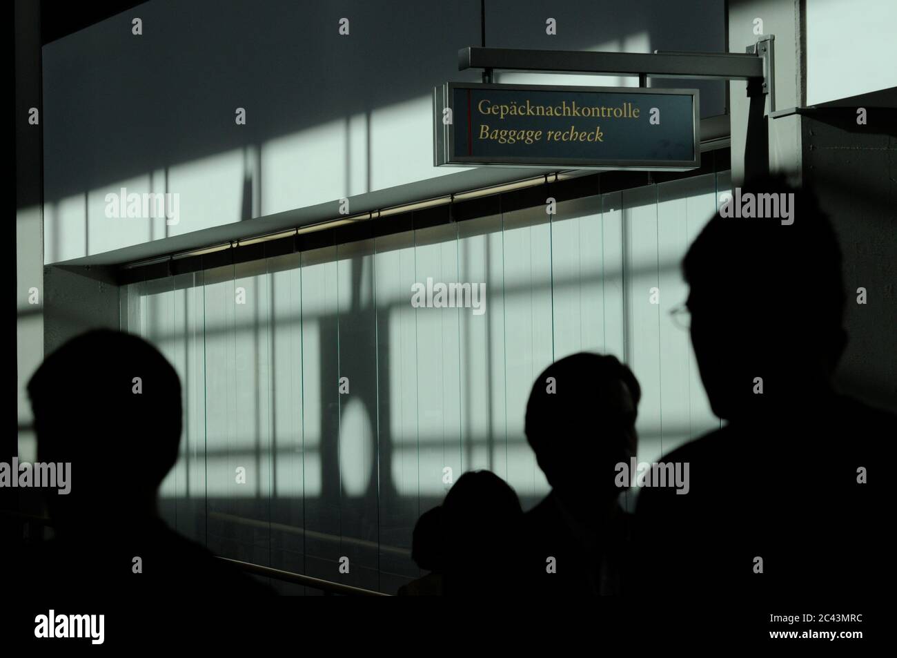 Passengers under baggage check sign at airport, Hamburg, Germany Stock ...