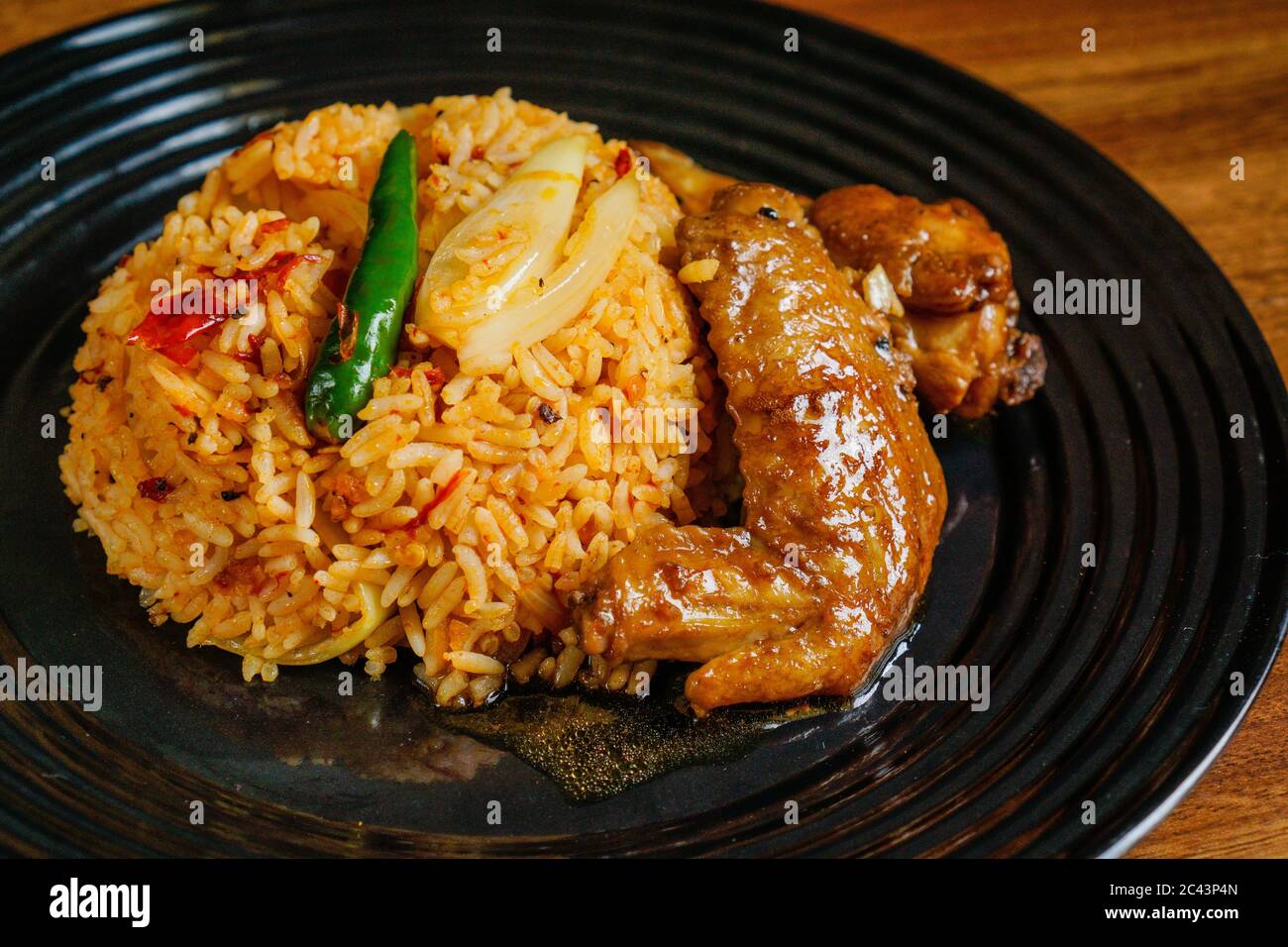 Spicy fried rice with grilled black pepper chicken wings Stock Photo ...