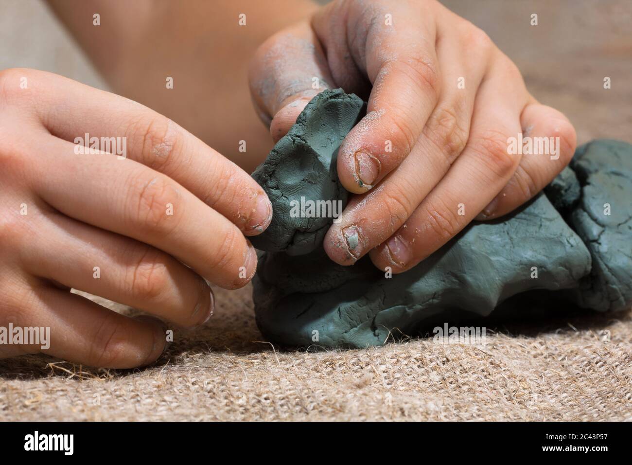 blue raw clay in the hands of child Stock Photo - Alamy