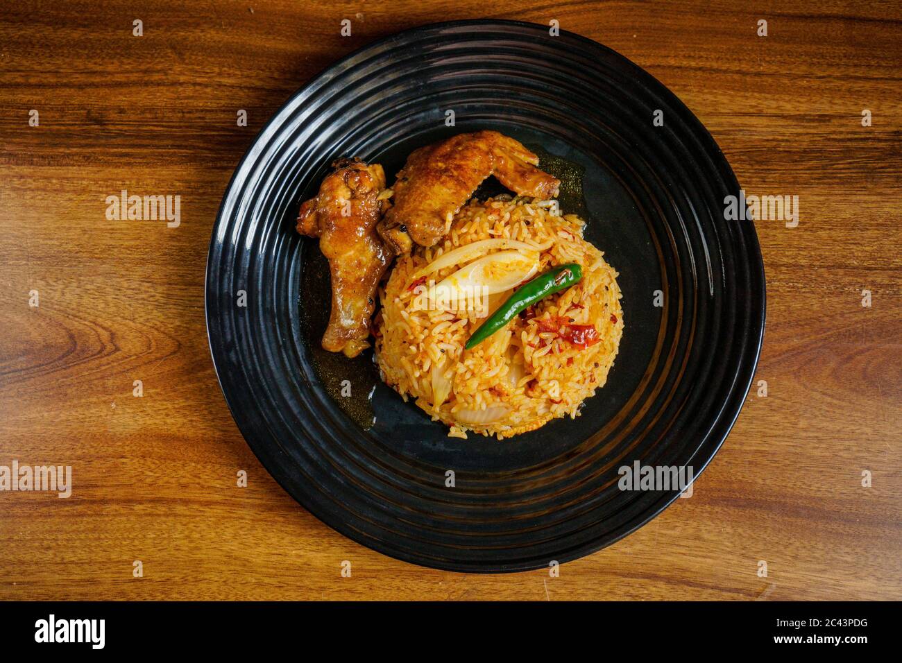 Spicy fried rice with grilled black pepper chicken wings Stock Photo ...