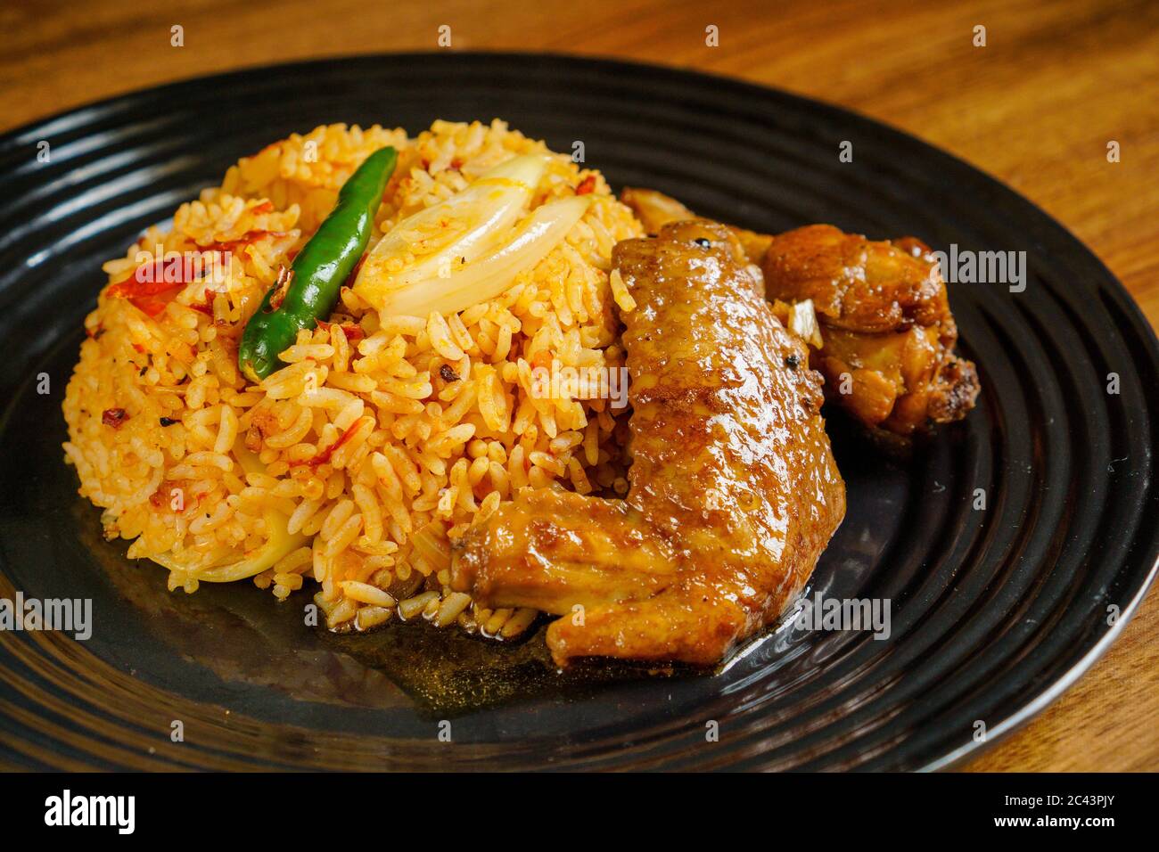 Spicy fried rice with grilled black pepper chicken wings Stock Photo ...