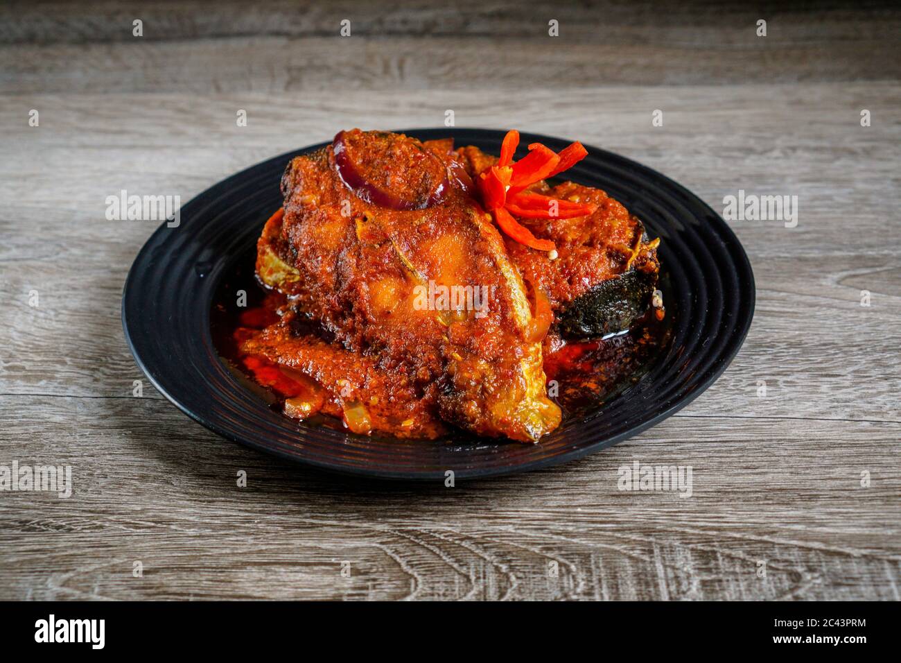 Fried silver catfish cooked with spicy sambal red chilli and onion with ...