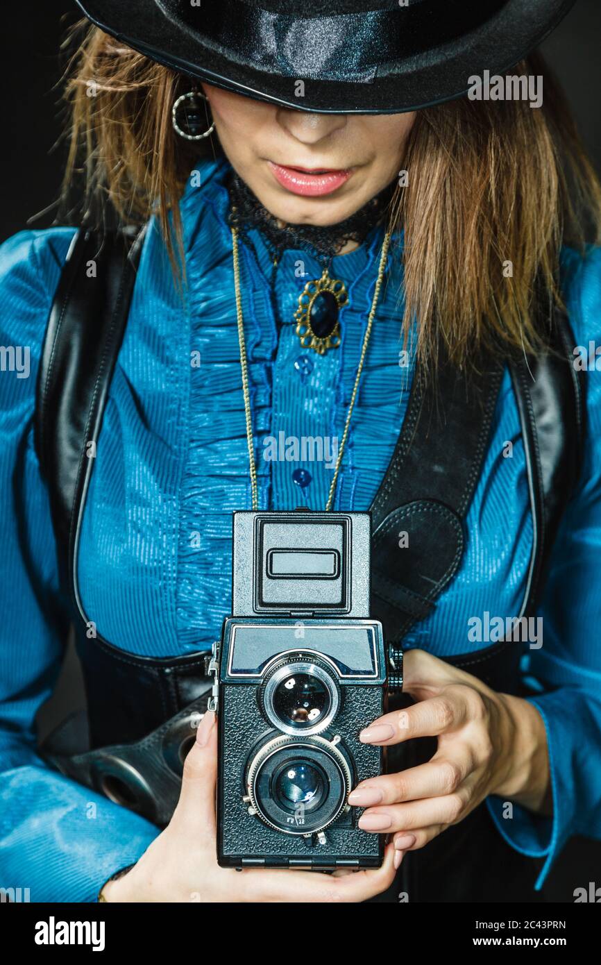 Photography and retro style. Young vintage attractive girl holds old ...