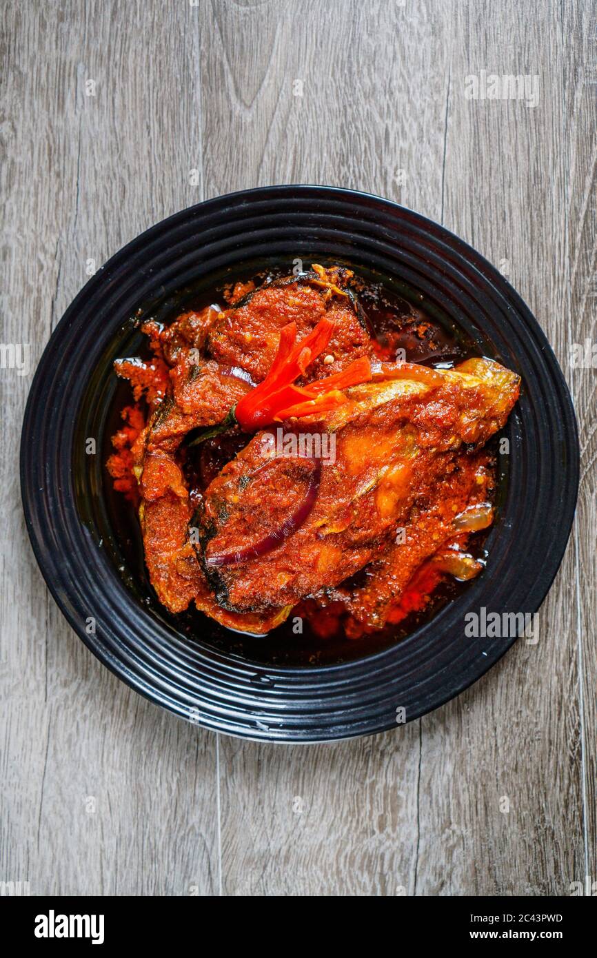 Fried silver catfish cooked with spicy sambal red chilli and onion with ...
