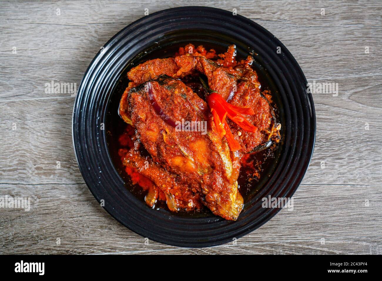 Fried silver catfish cooked with spicy sambal red chilli and onion with ...