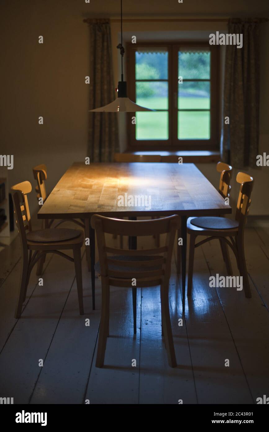 Ceiling lamp over a wooden table Stock Photo - Alamy