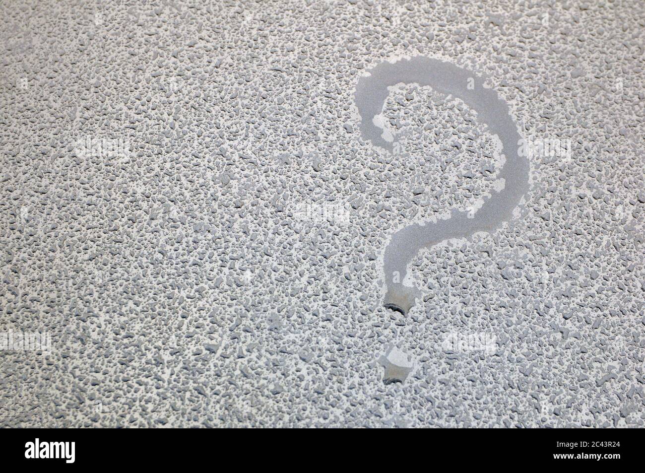 Question mark. The inscription on a wet metal surface. In the summer ...