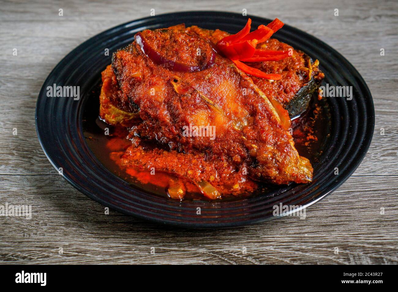 Fried silver catfish cooked with spicy sambal red chilli and onion with ...